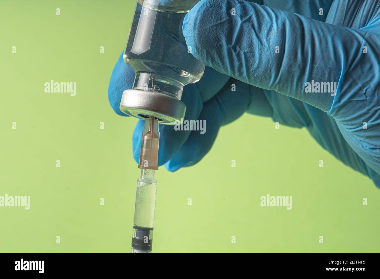 concept of vaccination with detail of the needle of a syringe inserted ...