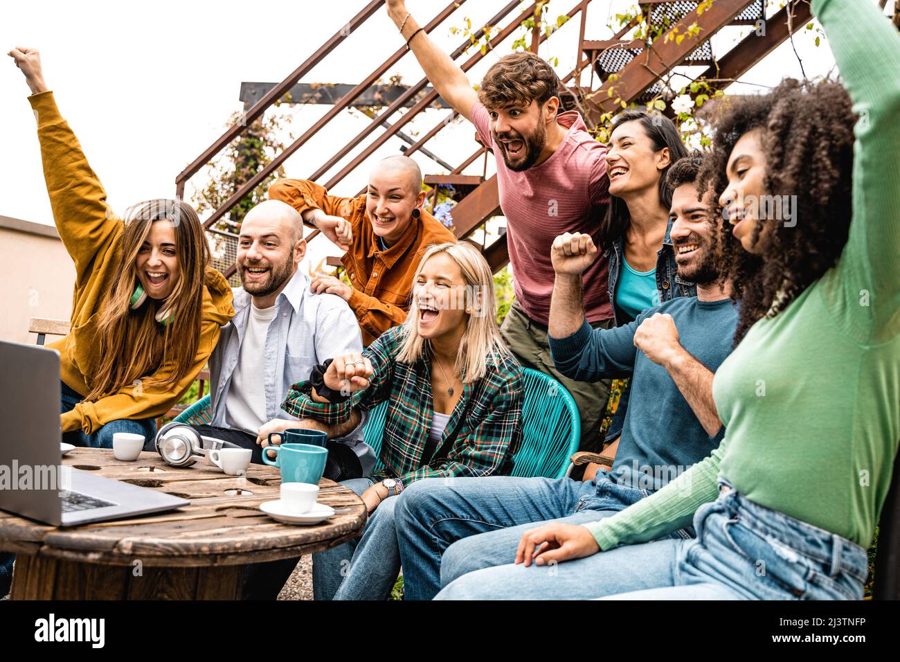Young people exulting watching the screen of a laptop computer ...