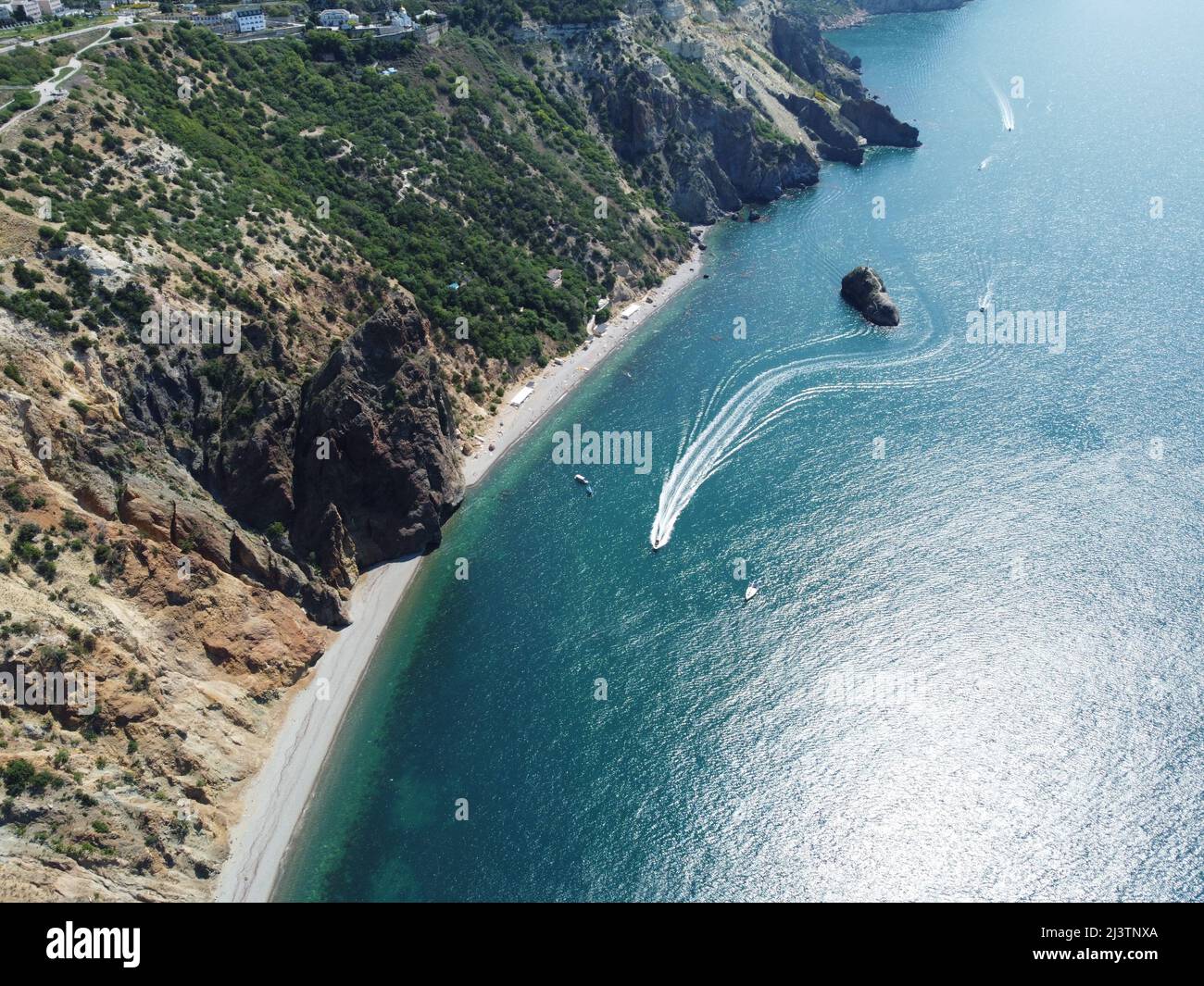Aerial view from above on calm azure sea and volcanic rocky shores ...