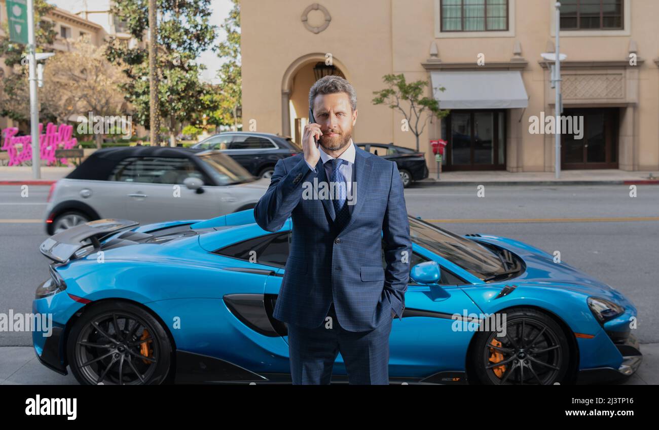 businessman talk on phone next to luxury car Stock Photo - Alamy