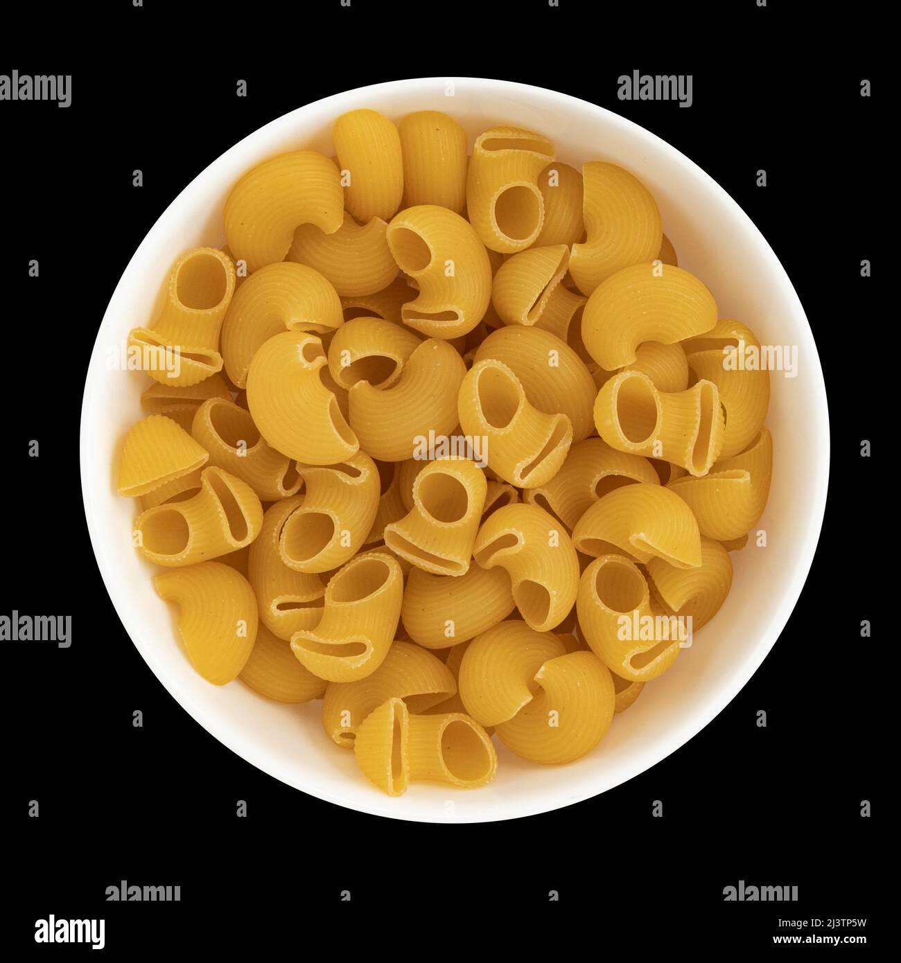 pipe rigate pasta in ceramic bowl isolated on black background, raw ...