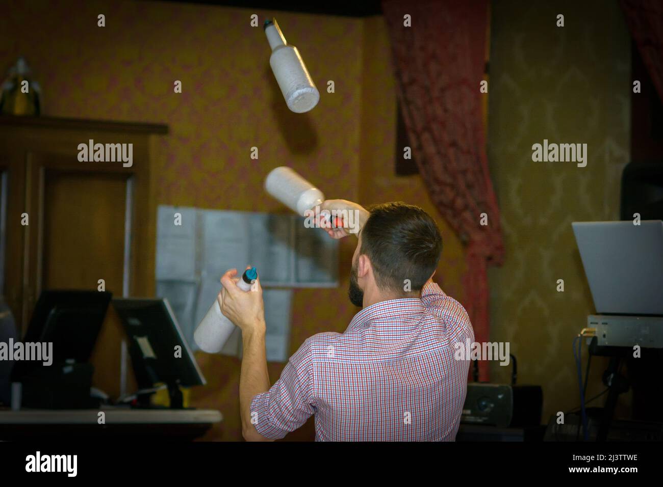Professional bartender man juggling bottles hi-res stock photography ...