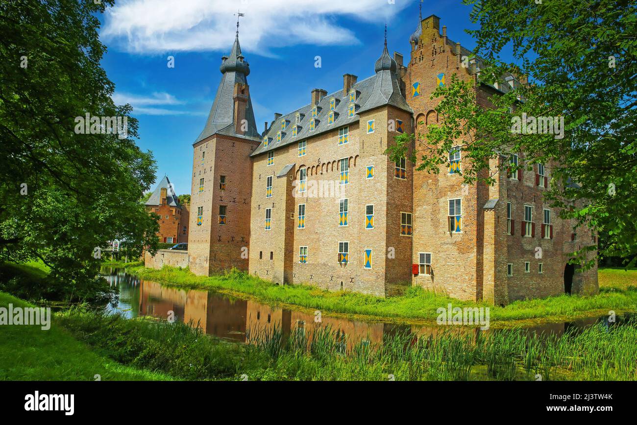 View beyond green park with moat on medieval dutch water castle from ...
