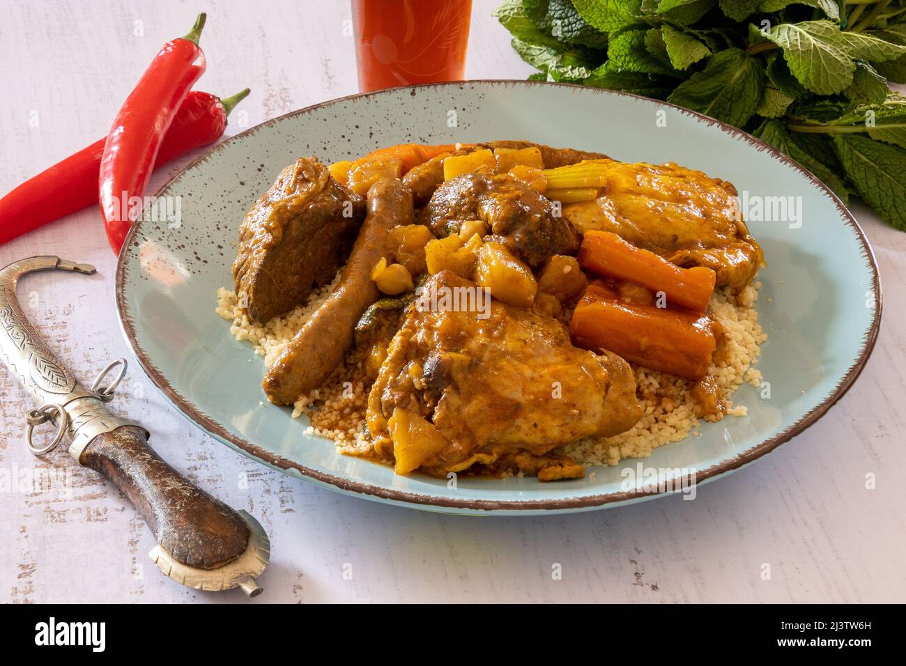royal couscous in a plate on a table with a glass of milk Stock Photo ...