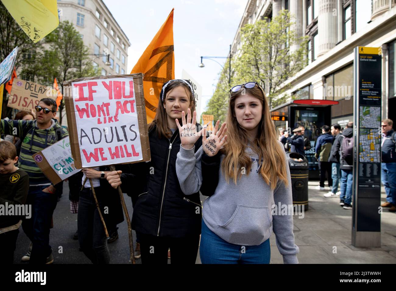 Protestor hold a placard and show their hands with writing to express ...