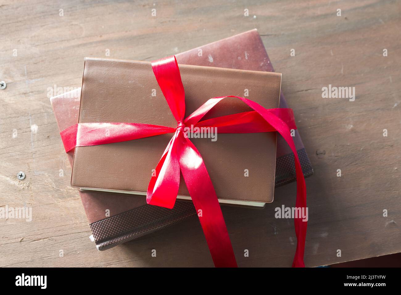 Books with gift ribbon. Book as a present Stock Photo - Alamy