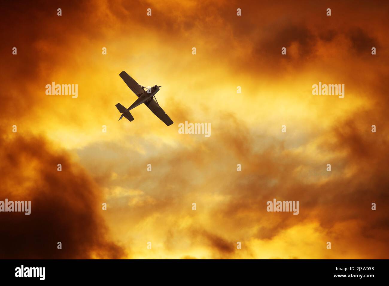 Airplane in the dramatic sunset sky Stock Photo - Alamy