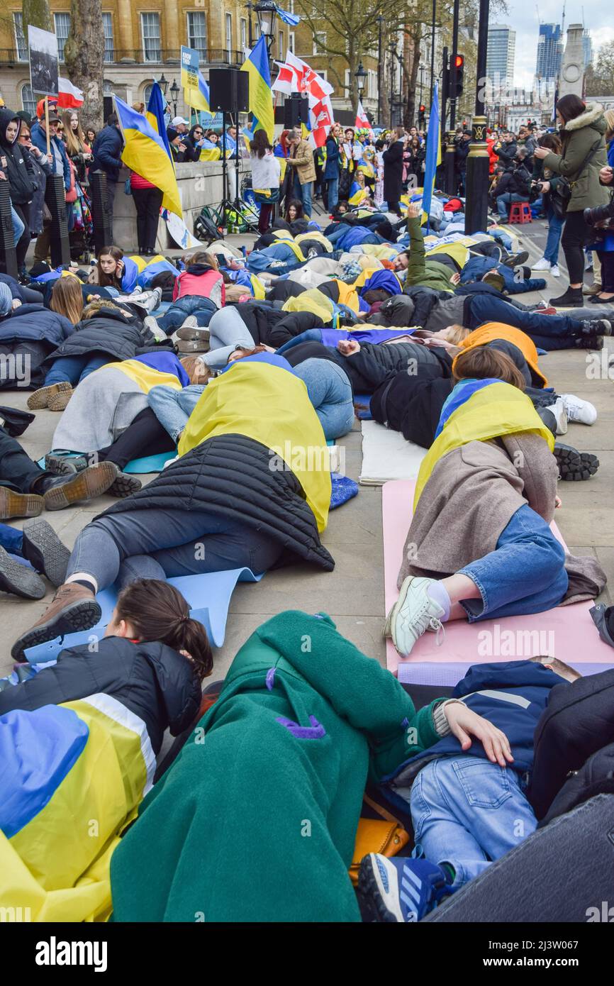 London, UK. 9th April 2022. Demonstrators staged a massive 'die-in' and ...