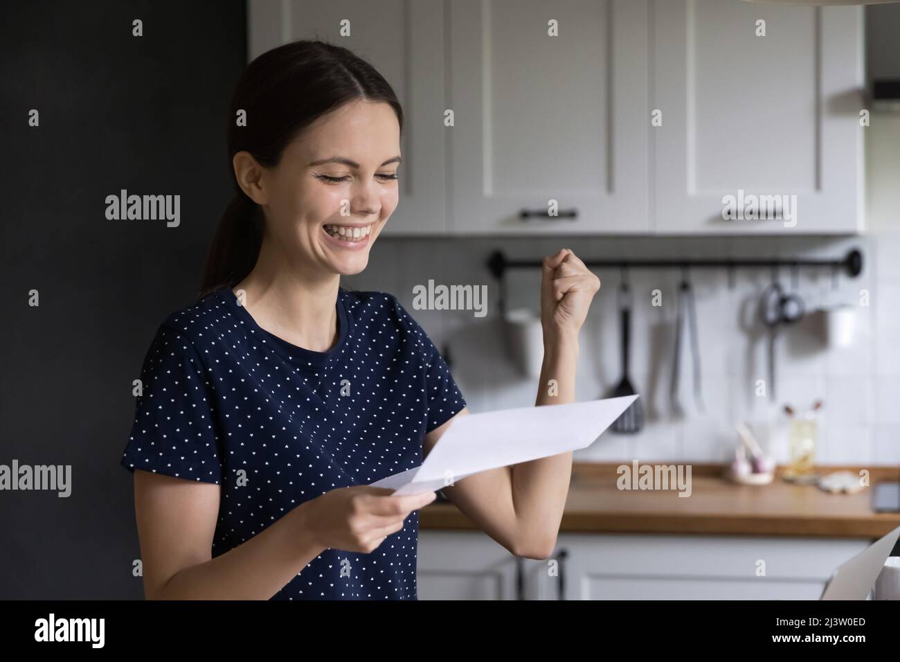 Happy woman read letter looks satisfied by good news Stock Photo - Alamy