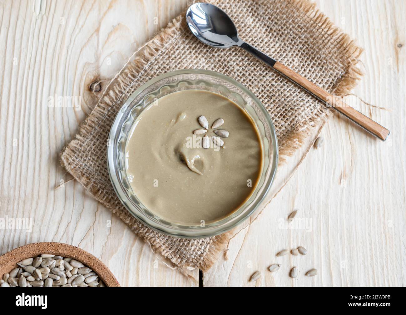Homemade sunflower seeds' butter or spread with roasted seeds on light ...