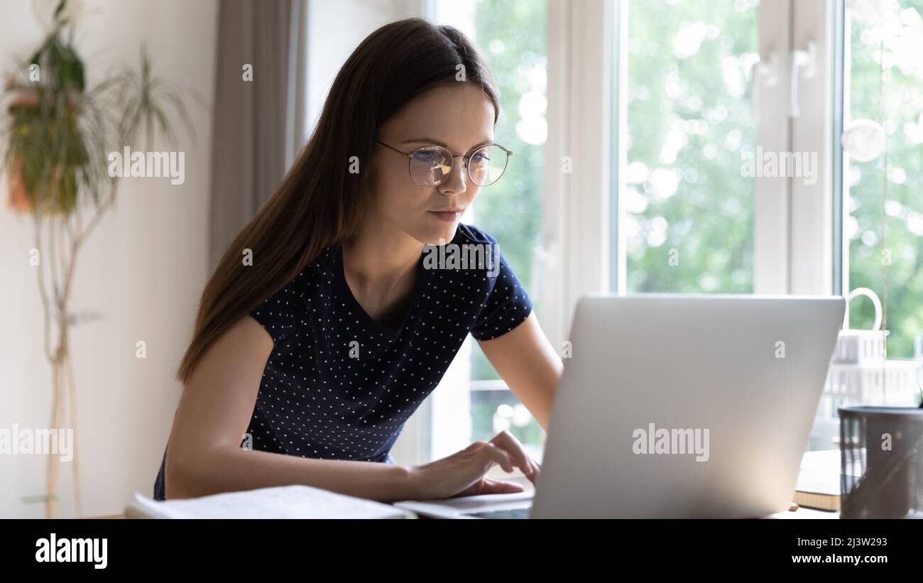Busy student girl in glasses studying use laptop Stock Photo - Alamy