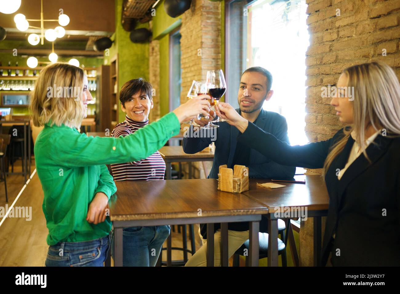 Man and women proposing toast during party Stock Photo - Alamy