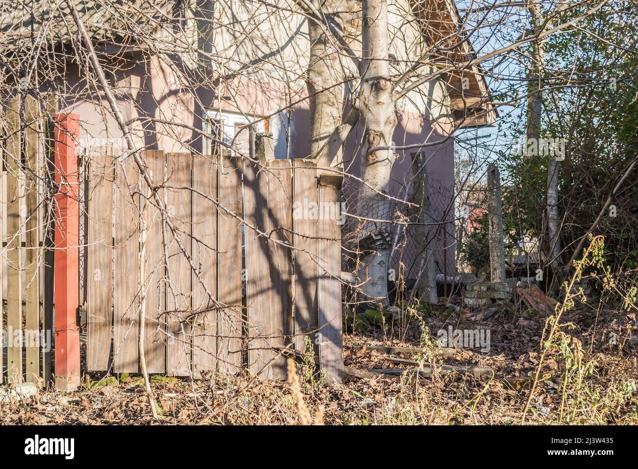 Abandoned wooden gate, old dilapidated houses on the outskirts of the ...