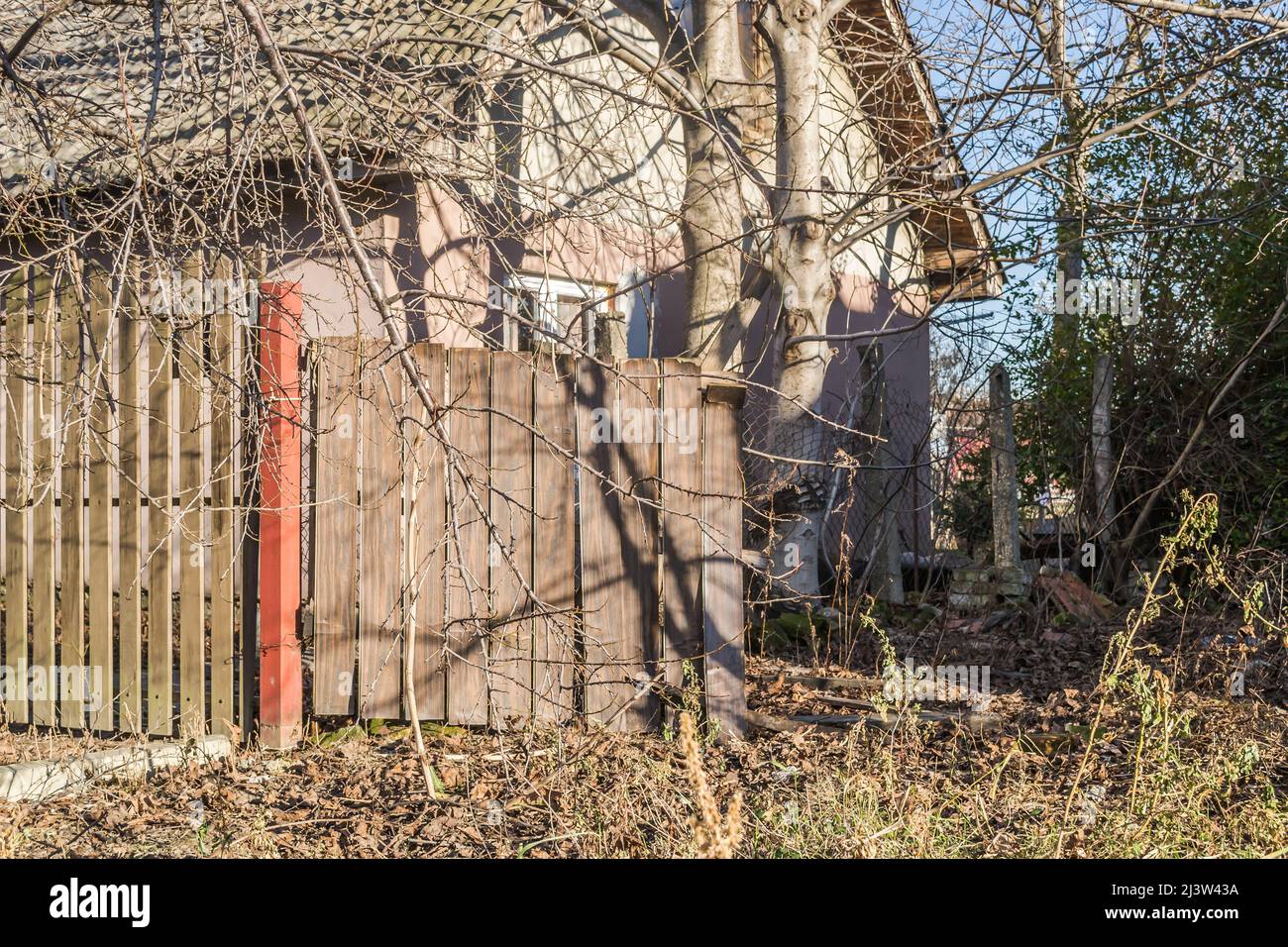 Abandoned wooden gate, old dilapidated houses on the outskirts of the ...