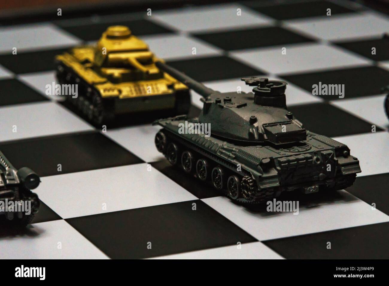 Toy tanks on a chessboard. The concept of military strategy Stock Photo ...