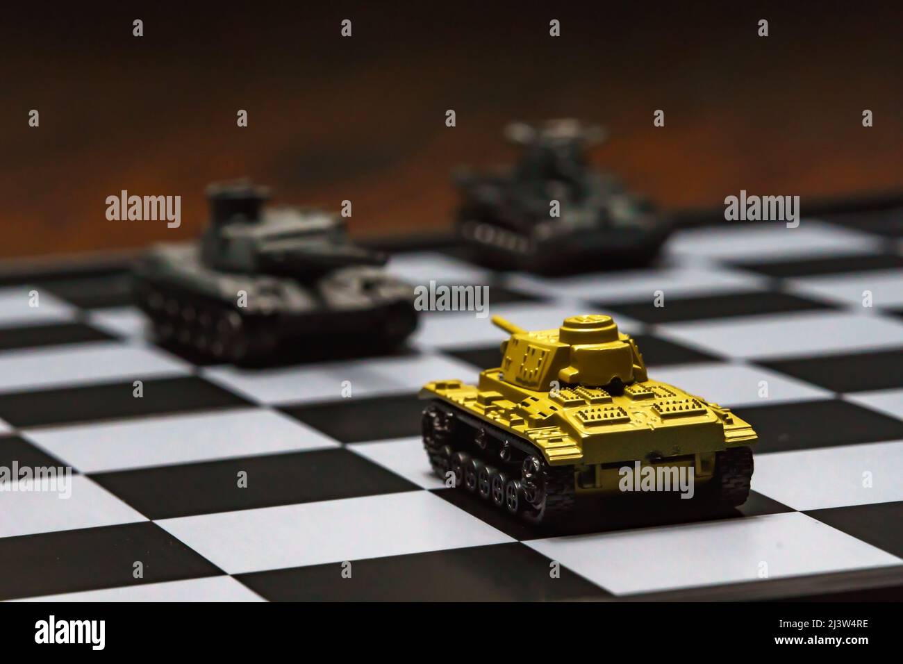 Toy tanks on a chessboard. The concept of military strategy Stock Photo ...