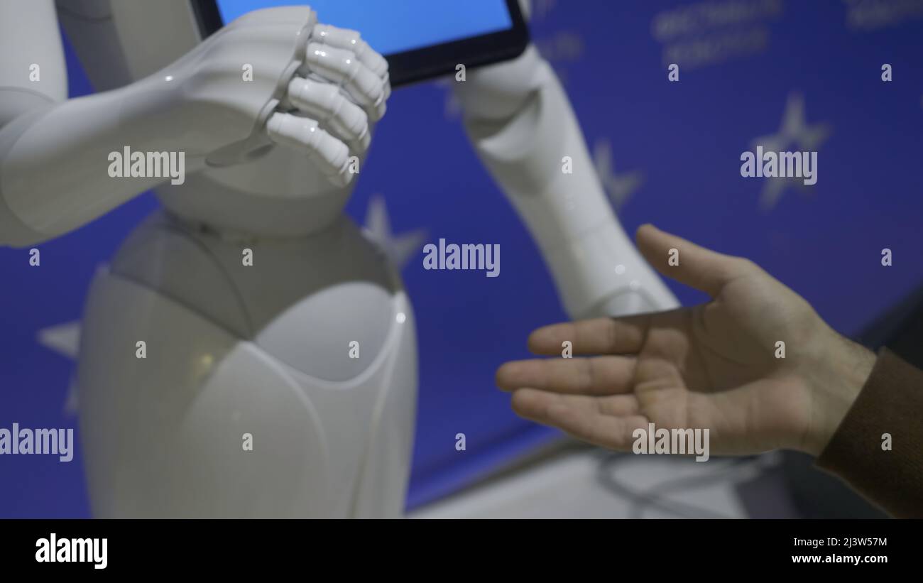 Close-up of man greeting cyborg. HDR. Showing developed and improved ...