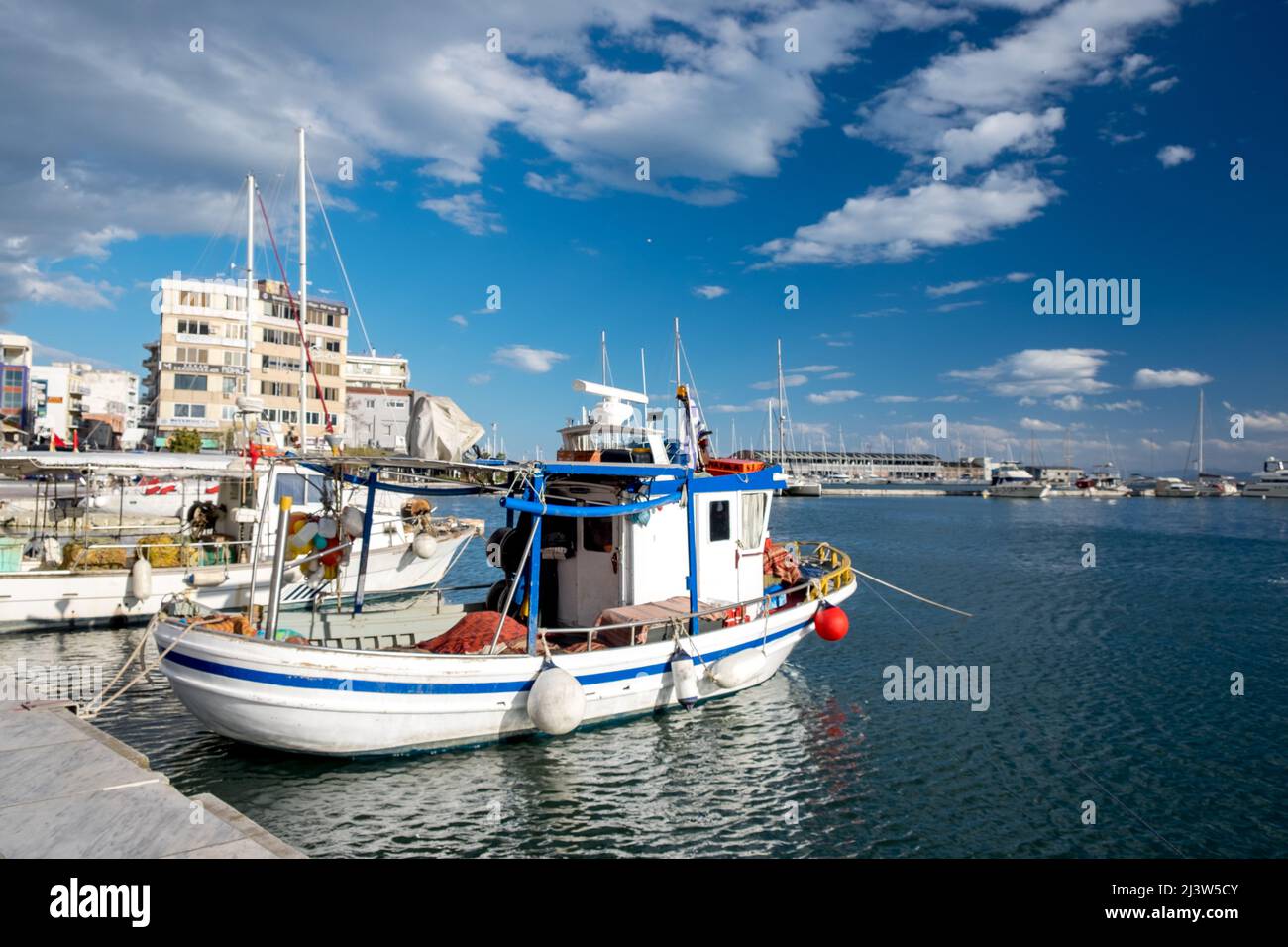 Seascape scenery with fishing boats and big port cranes on the harbor ...