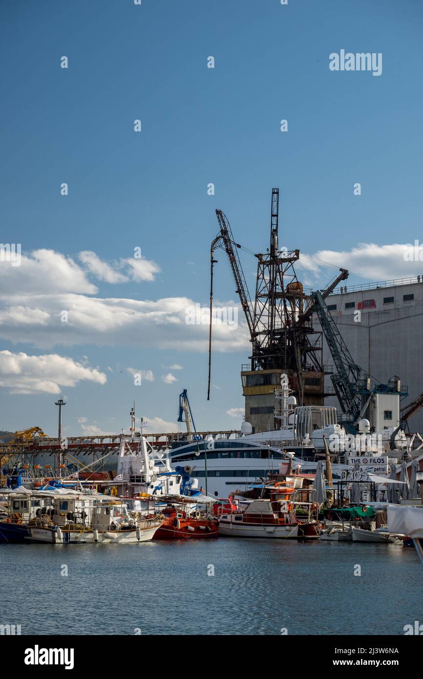 Seascape scenery with fishing boats and big port cranes on the harbor ...