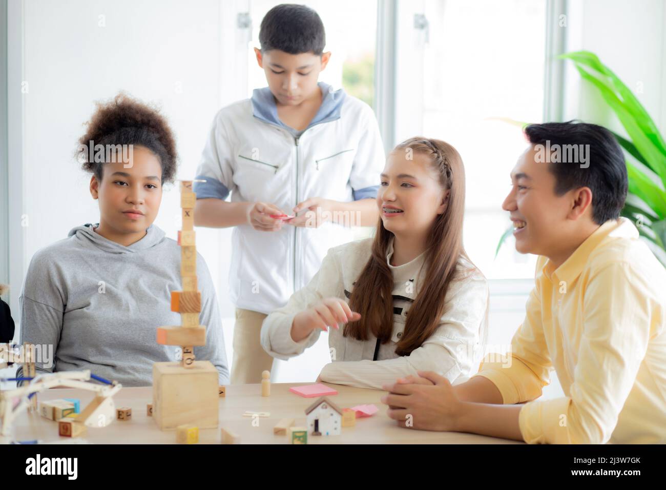 Young teacher and student doing activity playing block wooden for ...
