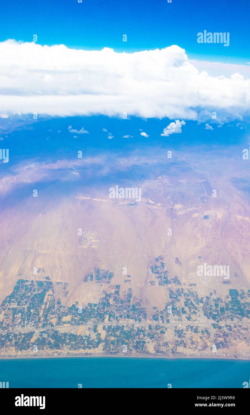 Aerial view of the coastline at the Gulf of Oman and Hajar Mountains ...