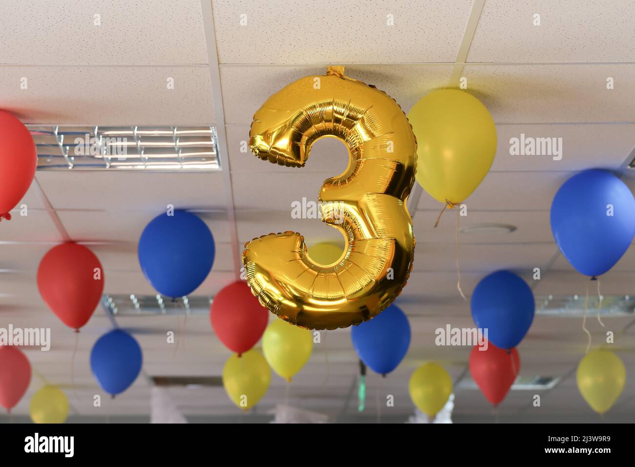 Number three golden balloon photo on the ceiling with other colourful ...