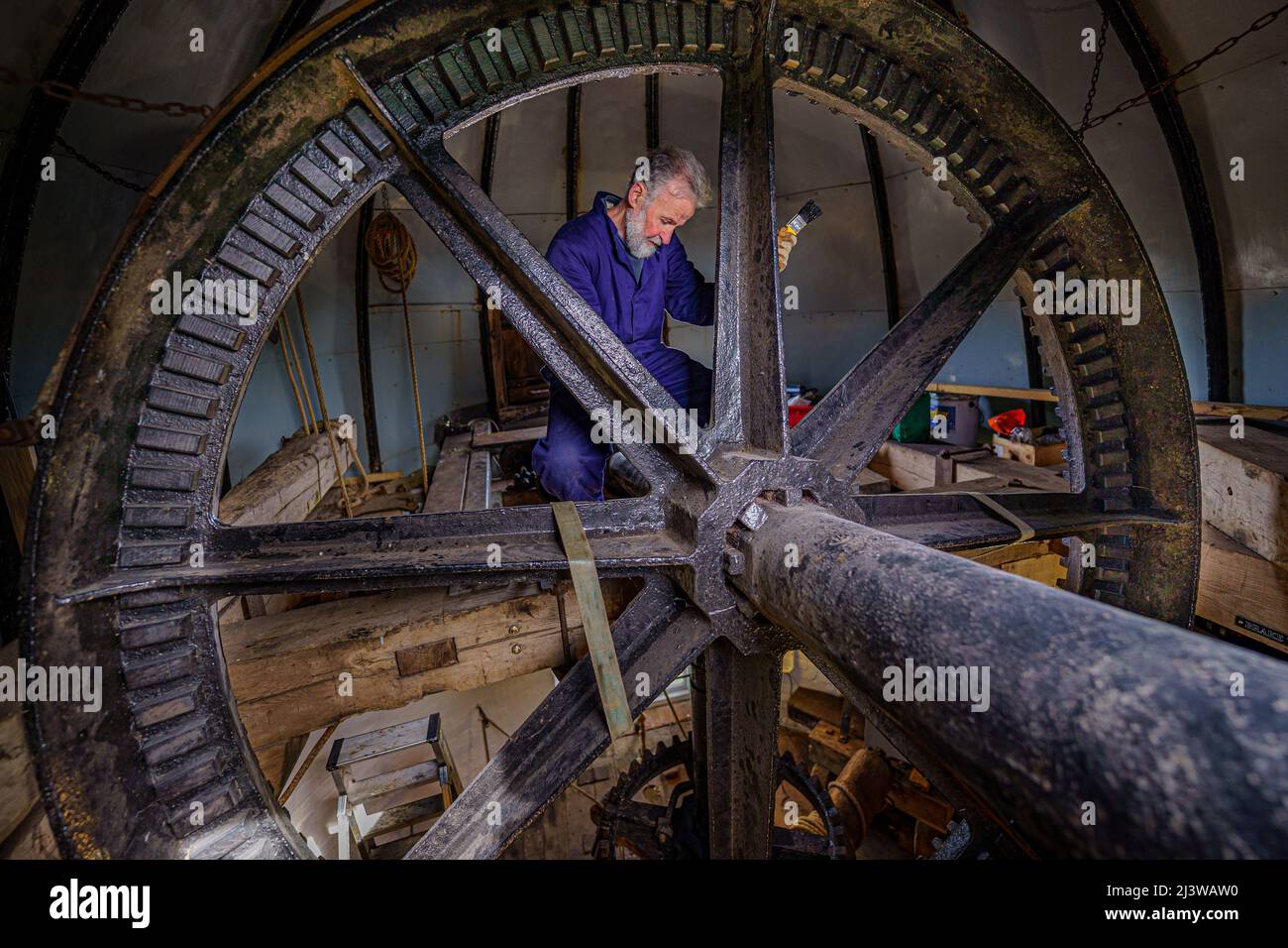 Volunteers clean and grease cogs inside Wilton windmill, Wiltshire ...