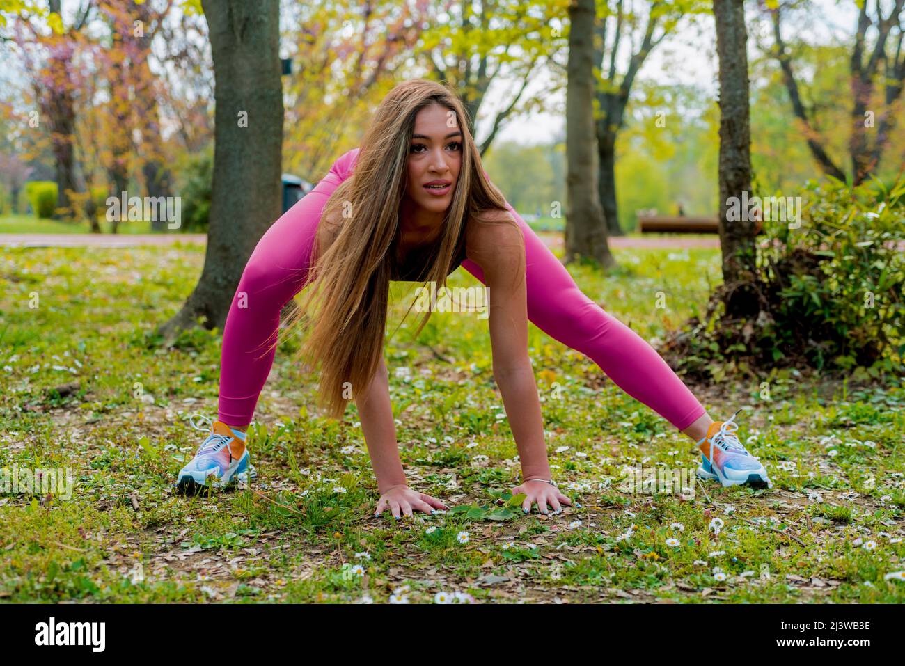 Fitness lifestyle, a young blonde stretching up from the exercises ...