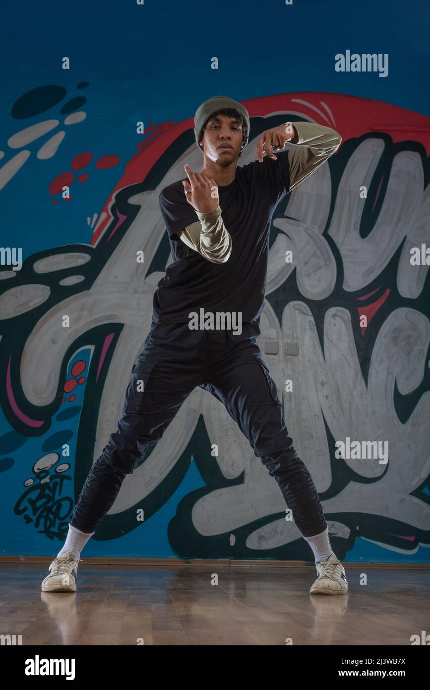 Modern rapper dancing in garage. Urban lifestyle, hip hop Stock Photo ...