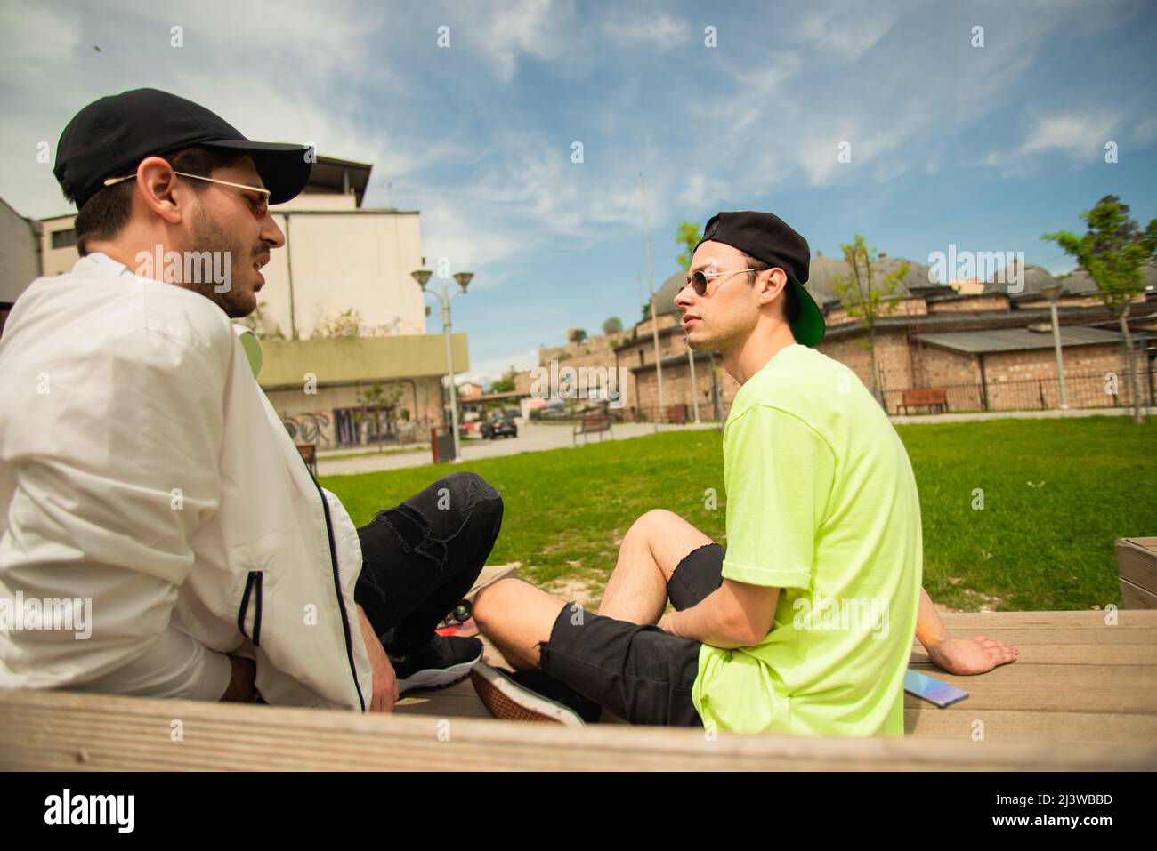 Two guys sitting on bench hi-res stock photography and images - Alamy
