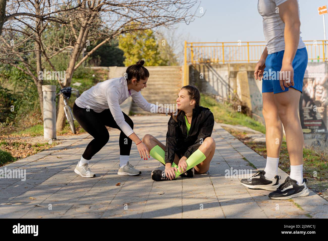 Attractive and beautiful fit girl is having a bad injury on her foot ...