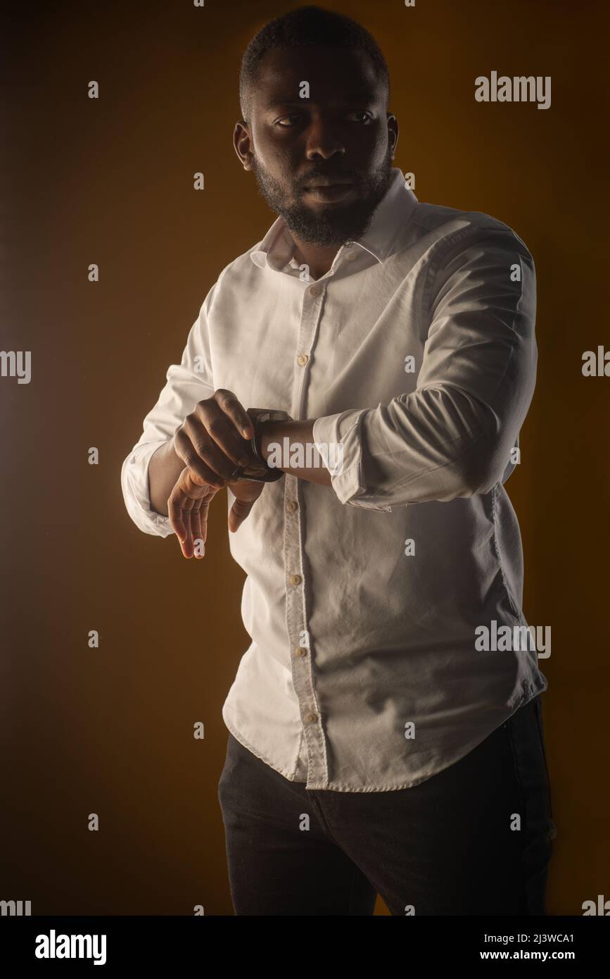 Formal dressed and handsome black guy is posing in studio Stock Photo ...