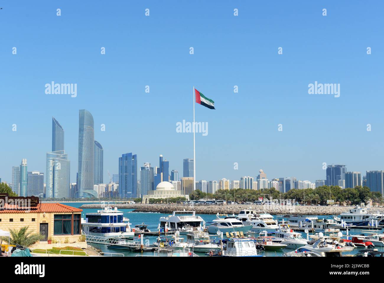 The UAE Flag and the skyline of the modern CBD near the Corniche in Abu ...