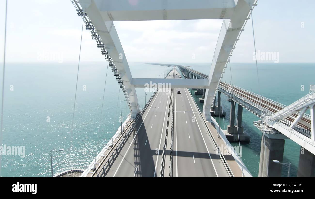 Top view of driving cars on bridge over river. Action. Motorway on ...