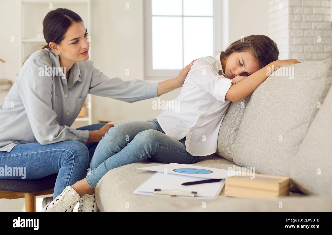 Therapist or psychologist helping sad child cope with stress ...