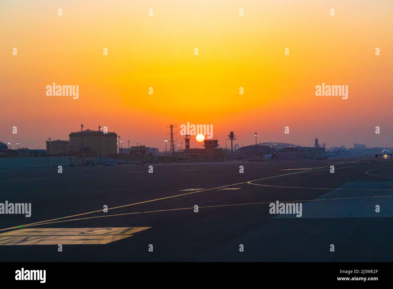 Sunset over Dubai International Airport runway,UAE Stock Photo - Alamy