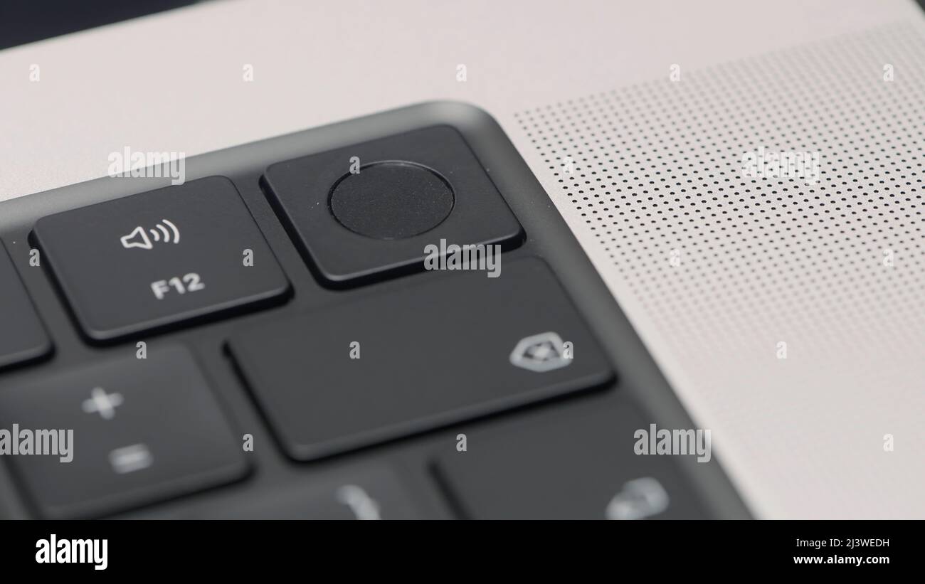 Extreme close up of black keyboard and silver laptop. Action. Buttons ...
