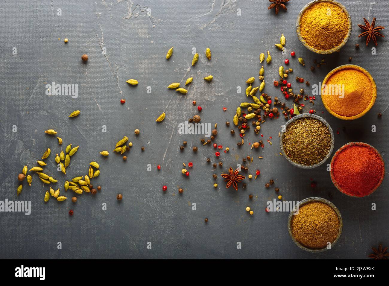 Wooden table of colorful spices. Dark.background. Top view Stock Photo ...