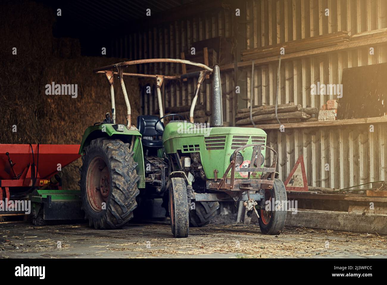 No farm is complete without one. Shot of a rusty old tractor standing ...