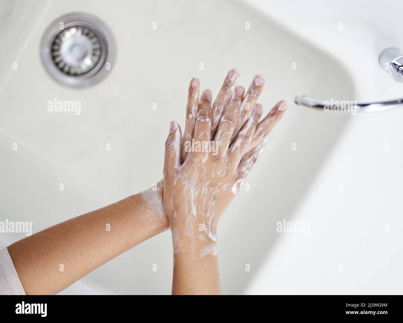 Wash your hands thoroughly. Shot of an unrecognizable person washing ...