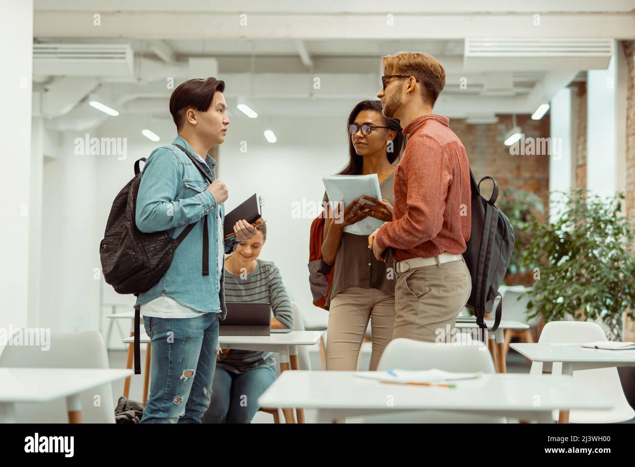 Students with backpacks standing and holding notebooks Stock Photo - Alamy