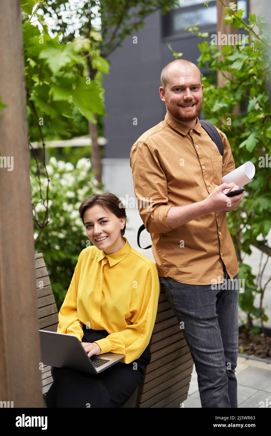 Business people working outdoor at the park. Cheerful businesswoman ...