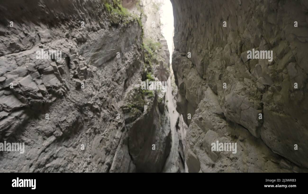 Geological formation with a very narrow passage. Action. Bottom view of ...
