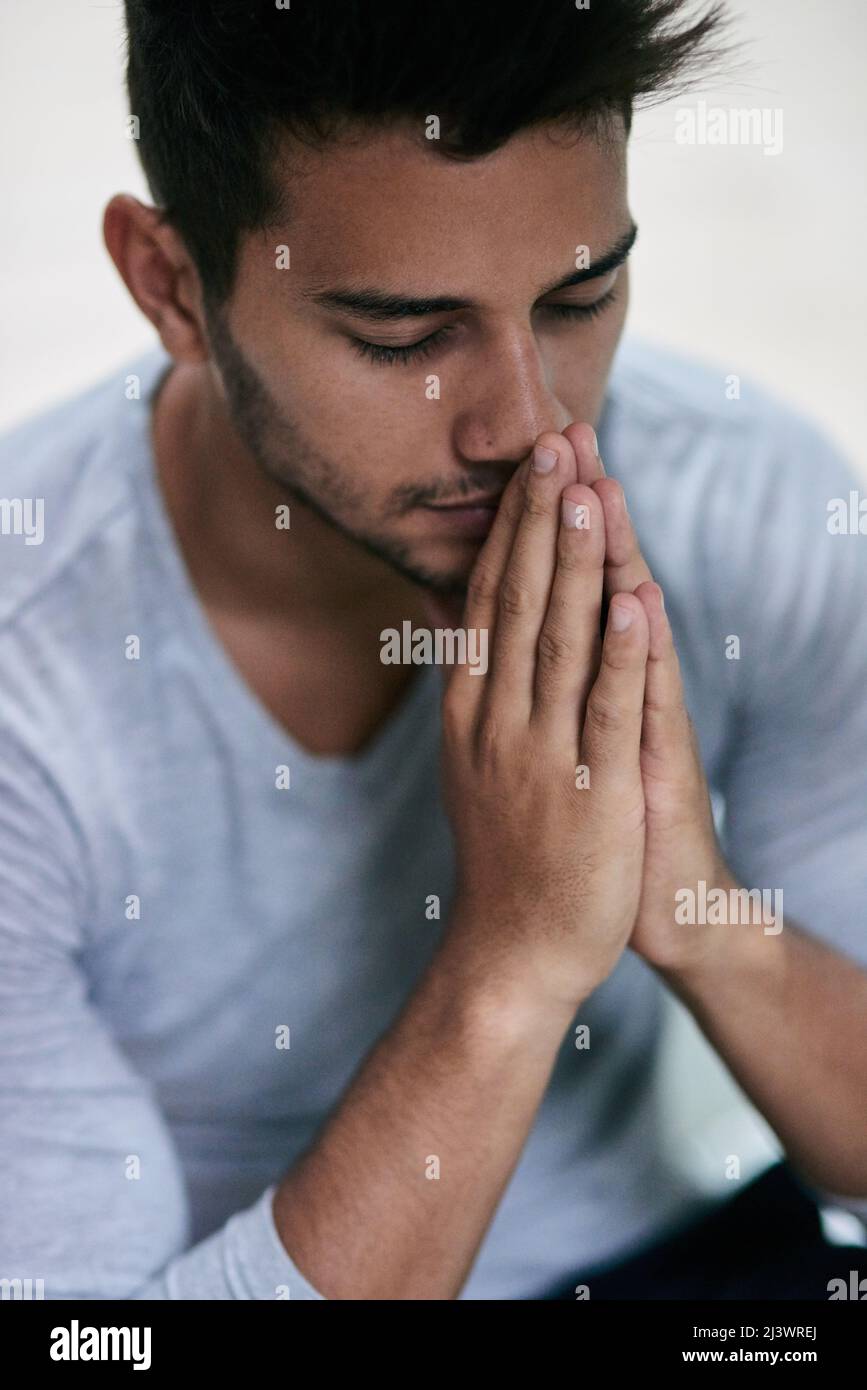 Give us this day our daily bread. Shot of a young man praying Stock ...