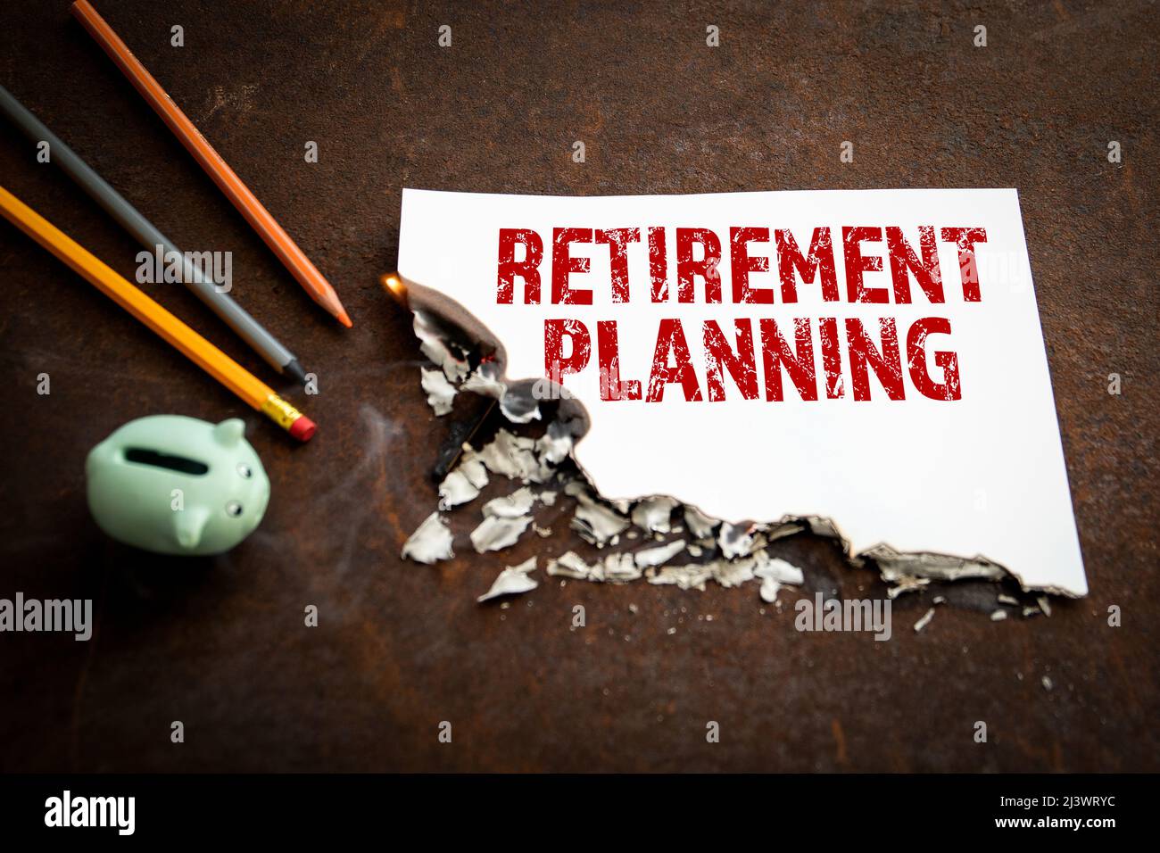 Retirement Planning. Burning sheet of paper with text. Rusty metal ...