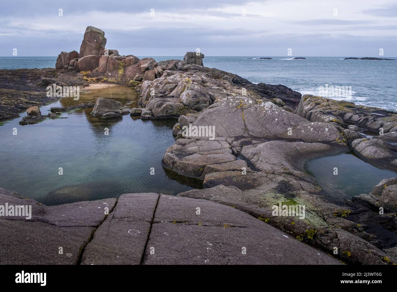 Crystal clear sea water in the rock pools at Ramore Head in the County ...