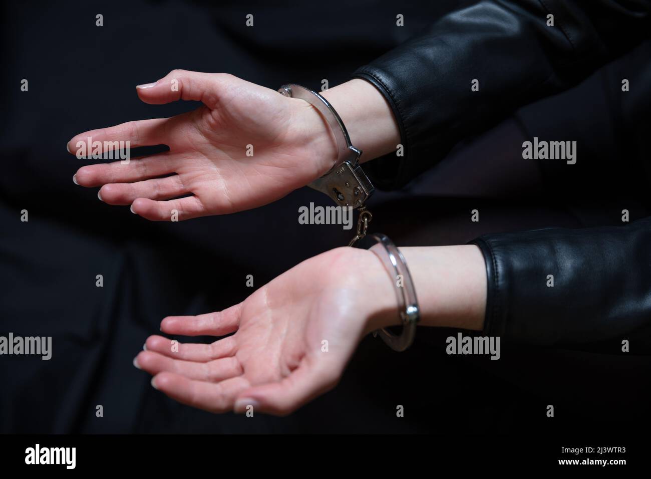 Arrest, Handcuffed criminal woman hands close up. Hand cuffs locked in ...