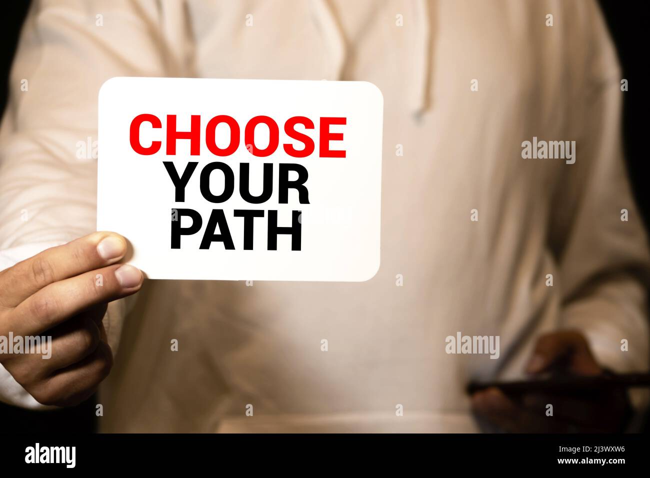 Closeup on businessman holding a card with text CHOOSE YOUR PATH ... Closeup on businessman holding a card with text CHOOSE YOUR PATH ...