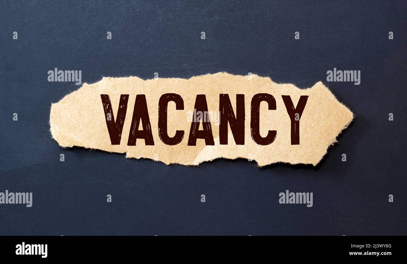The word vacancy on a white background with a yellow folder. Business ...