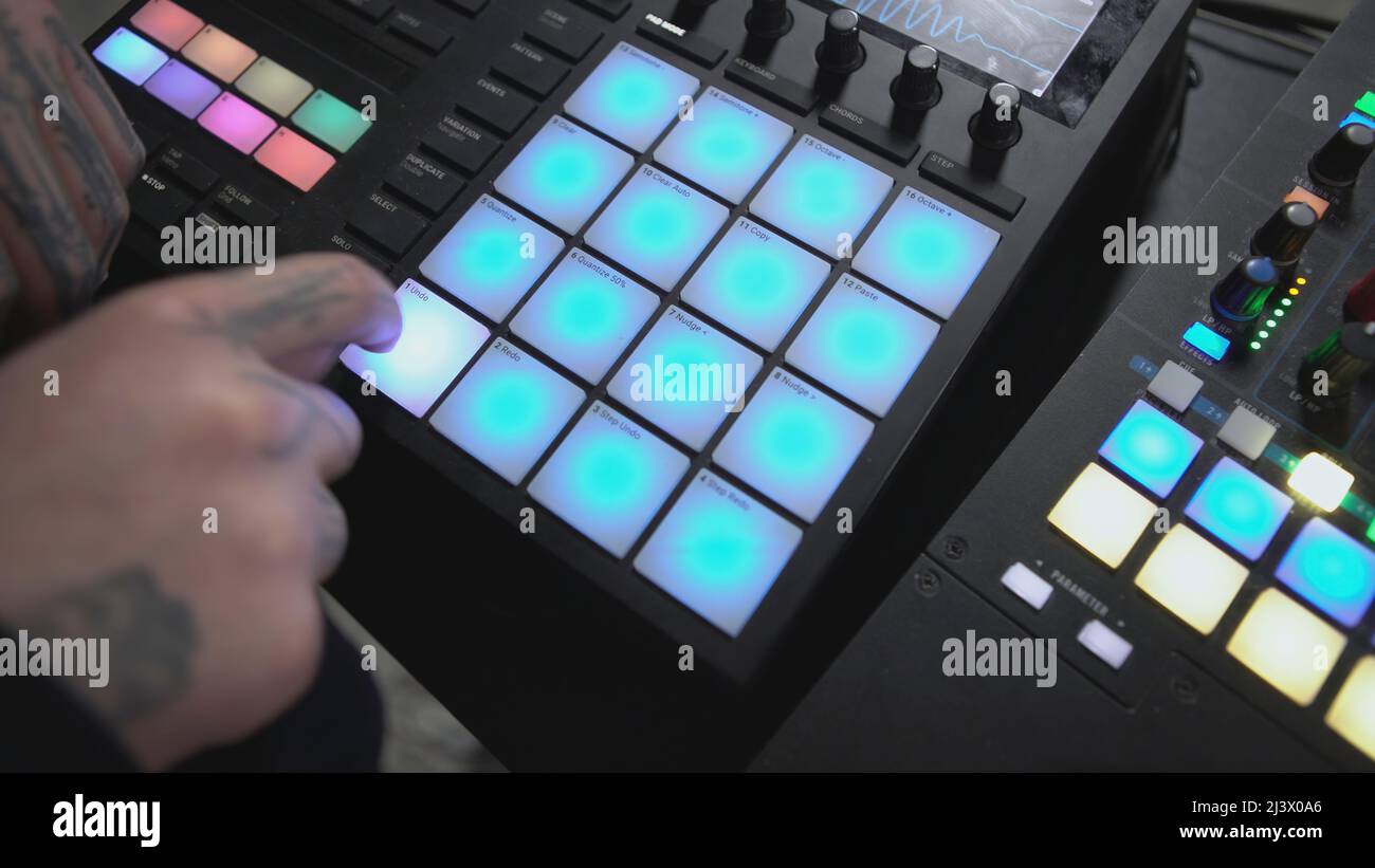 Click colored squares on mixer panel. ART. Hands in dark room are ...